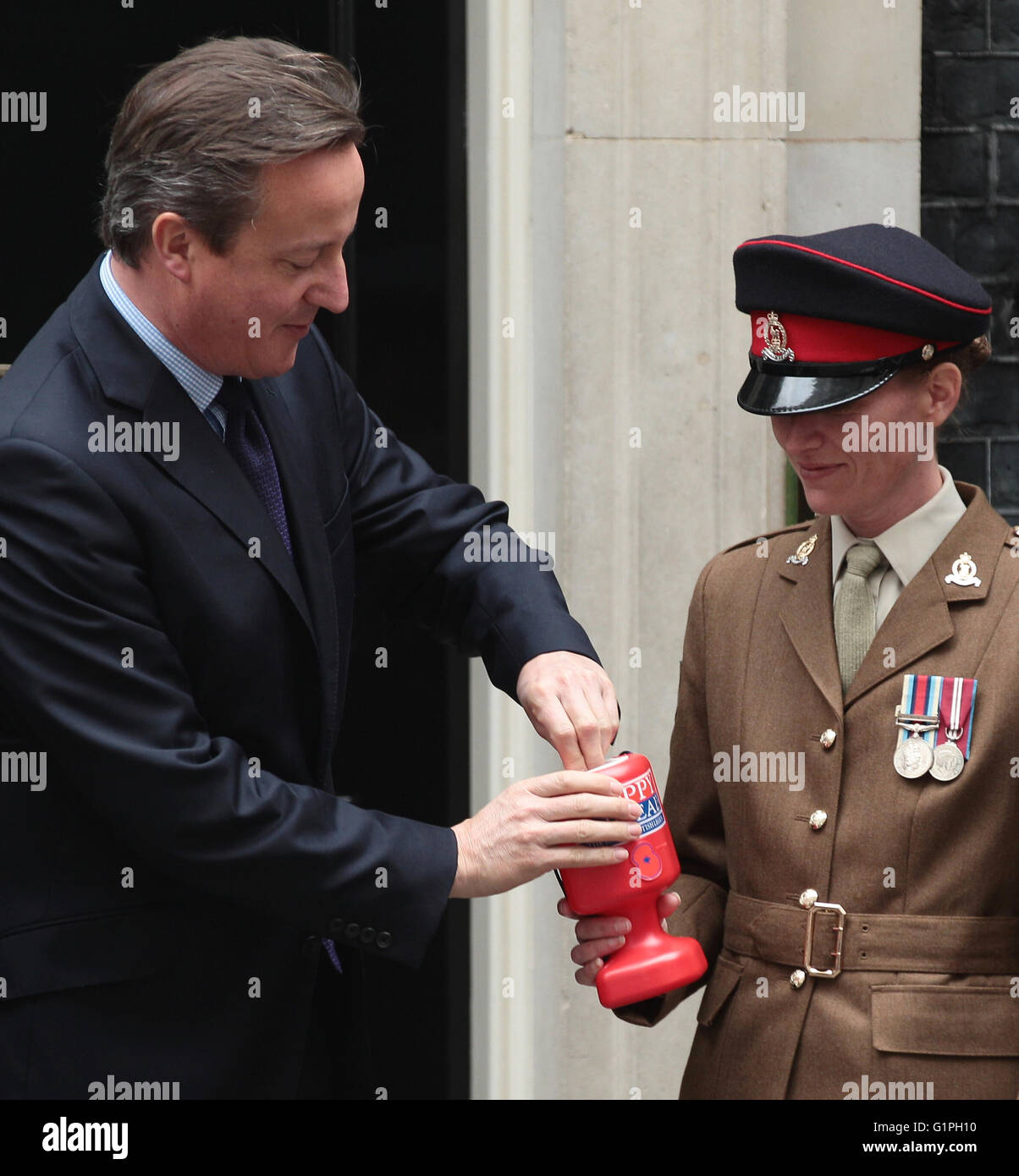 Prime Minister David Cameron buys his remembrance poppy from Corporal ...