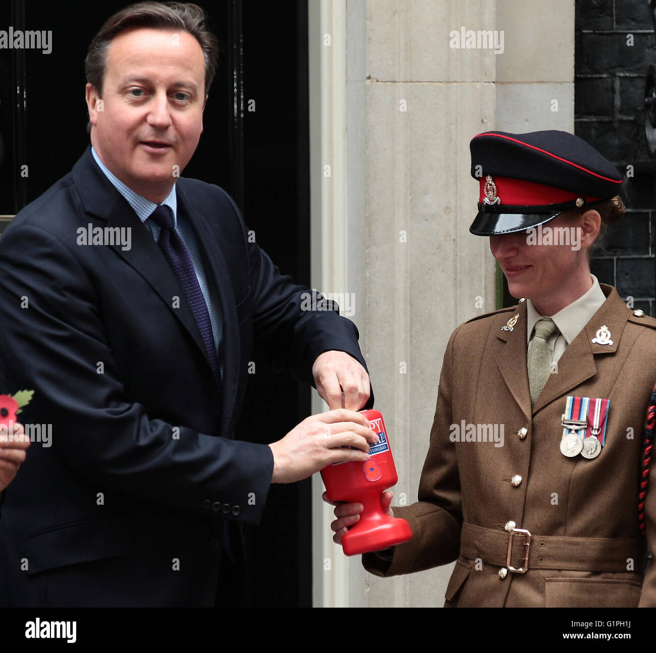 Prime Minister David Cameron buys his remembrance poppy from Corporal ...