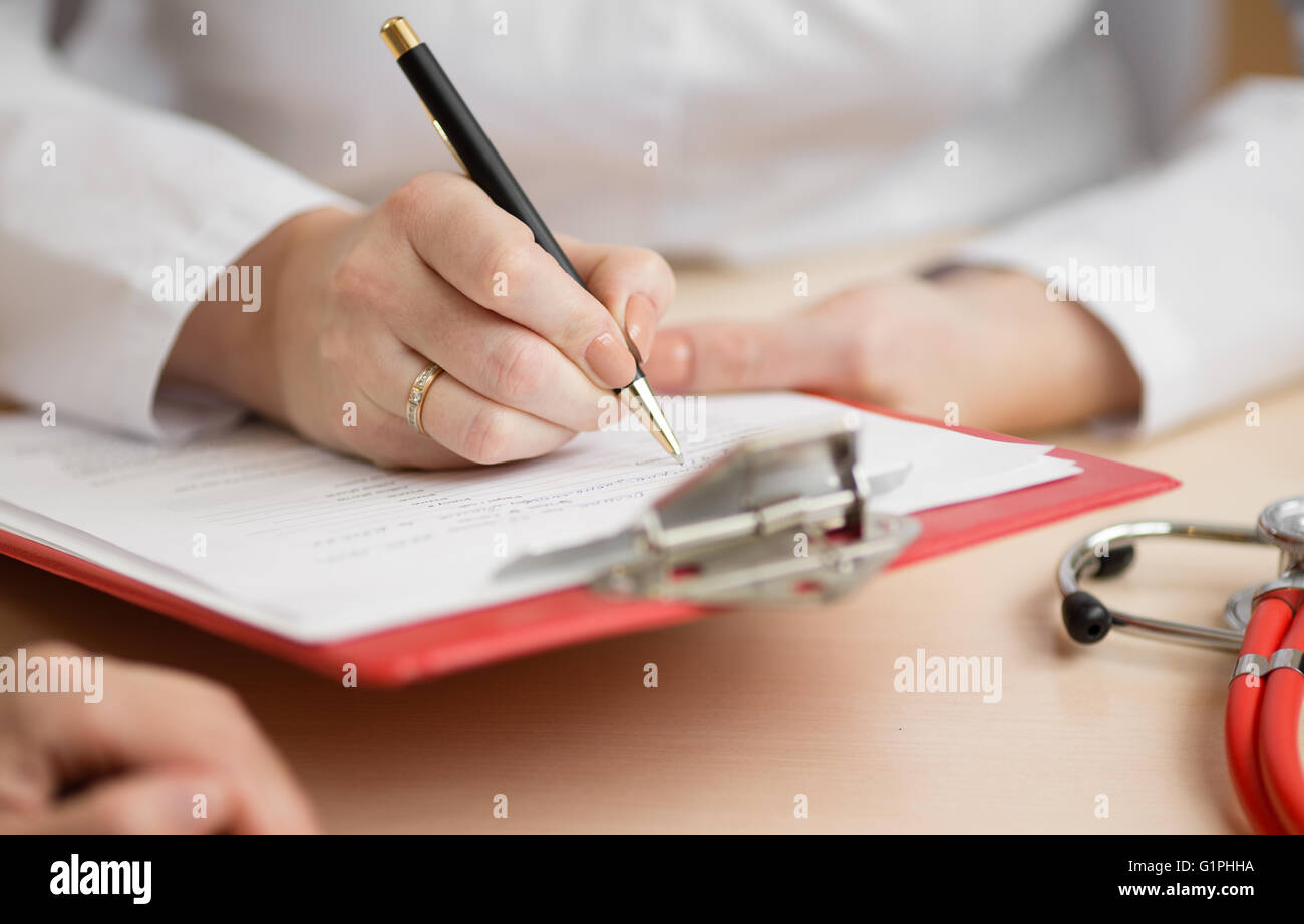 Doctor's desk during patient's consultation in office Stock Photo - Alamy