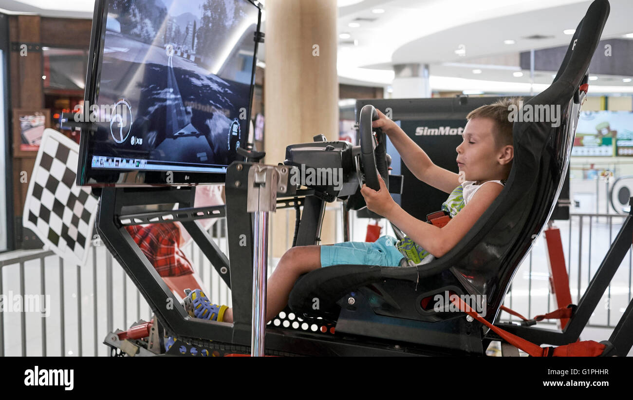 Virtual Reality game. Child playing a Virtual Reality motor racing game ...