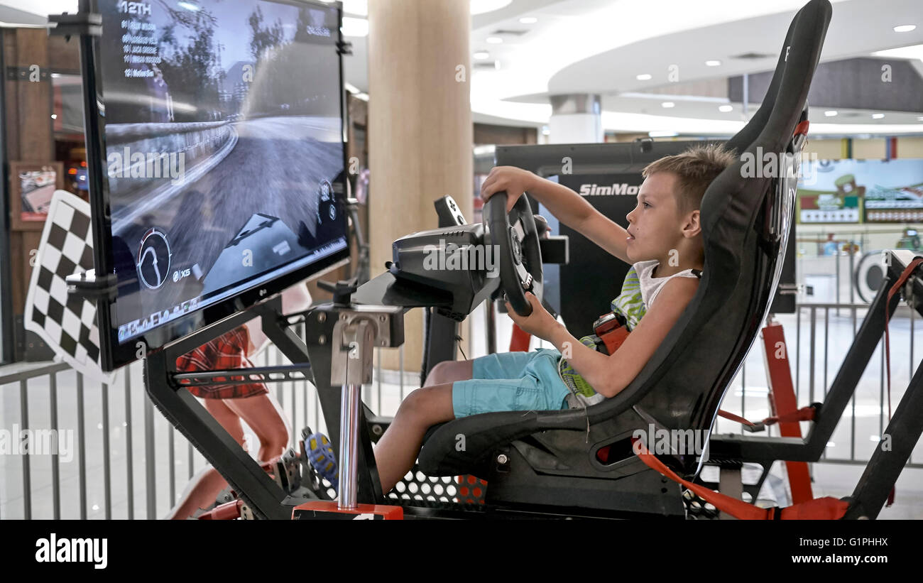 Virtual Reality game. Young boy playing a Virtual Reality motor racing ...
