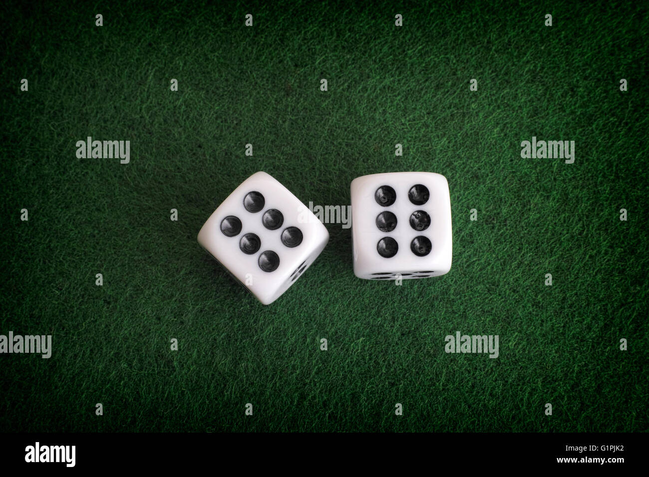 Two dices on a green background. Close up Stock Photo - Alamy