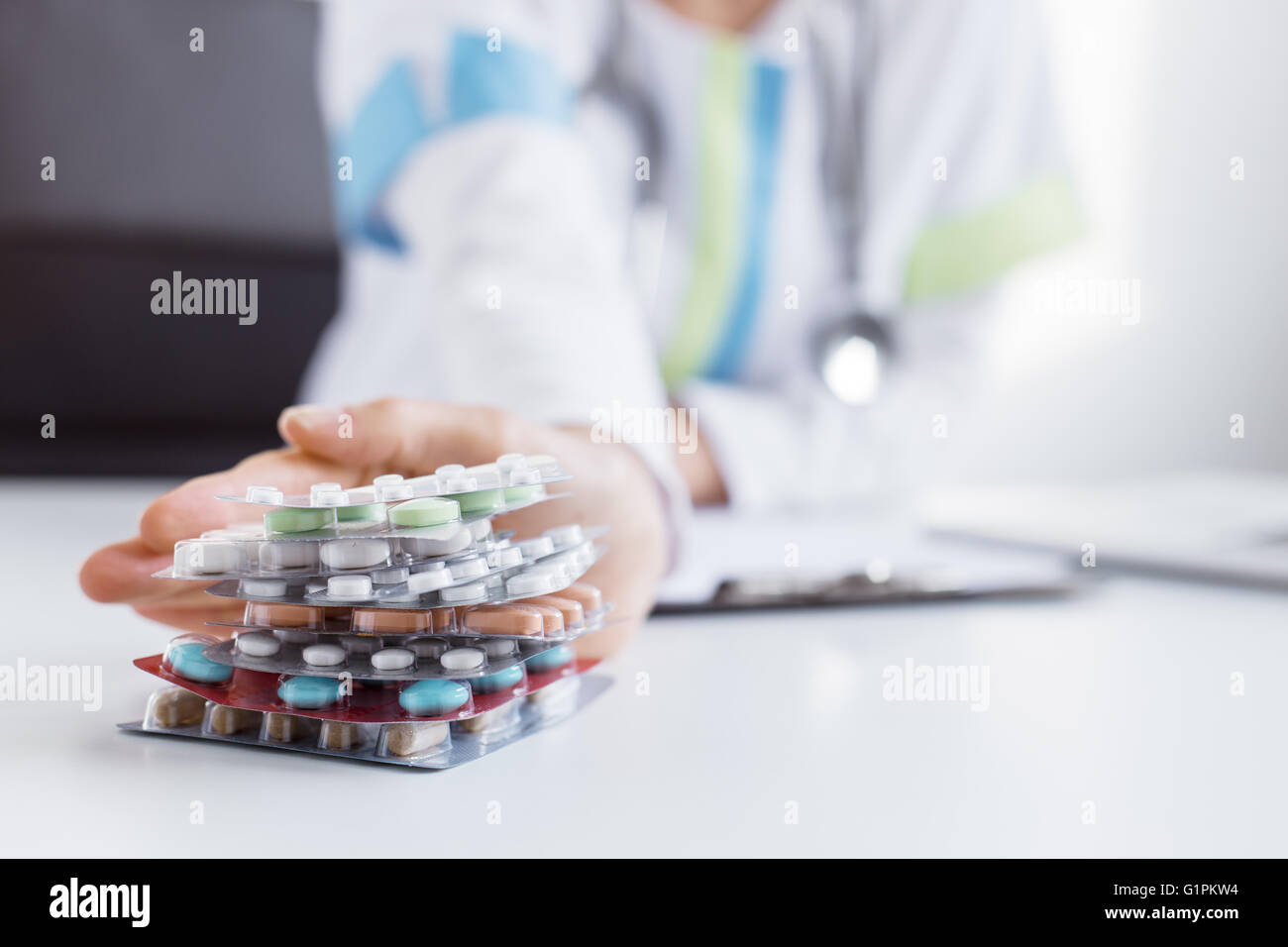 Doctor giving many medical tablets to patient Stock Photo - Alamy