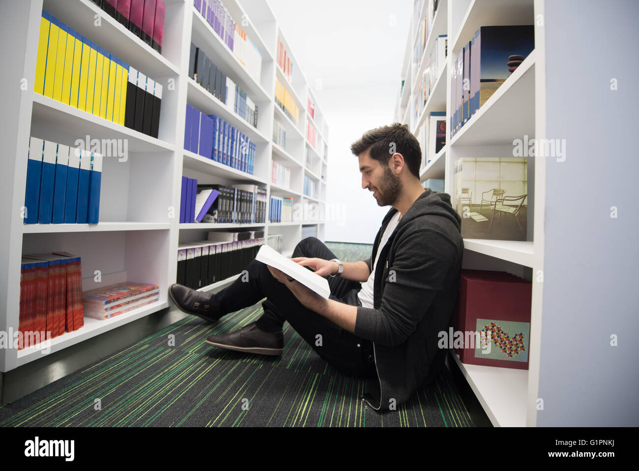 Student reading book in school library. Study lessons for exam. Hard ...