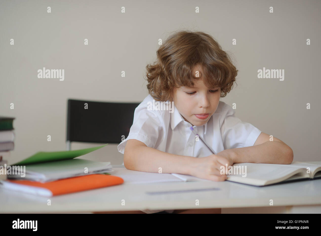 Student elementary school diligently doing homework Stock Photo - Alamy