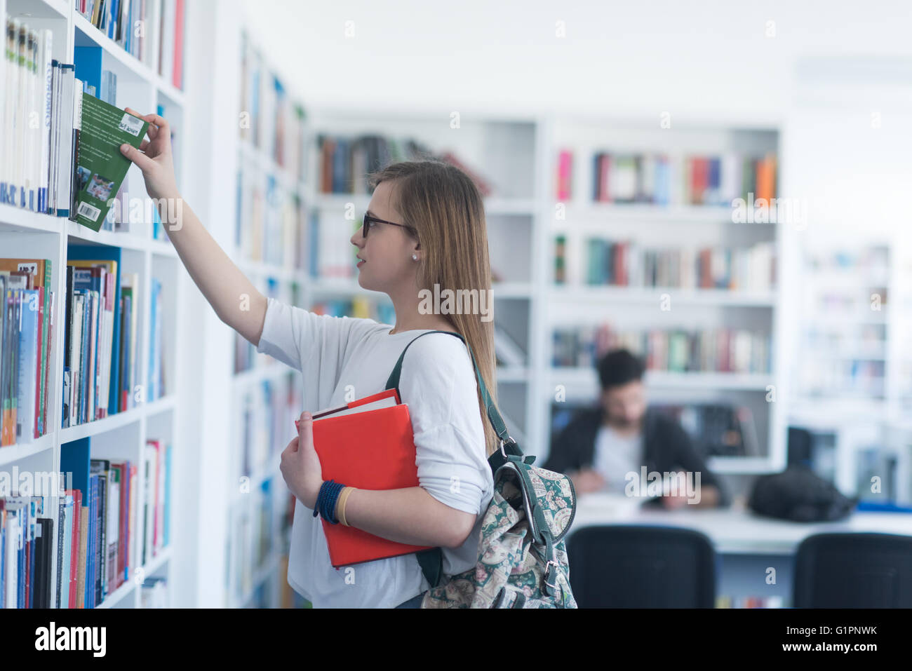 smart looking famale student girl in collage school library selecting ...