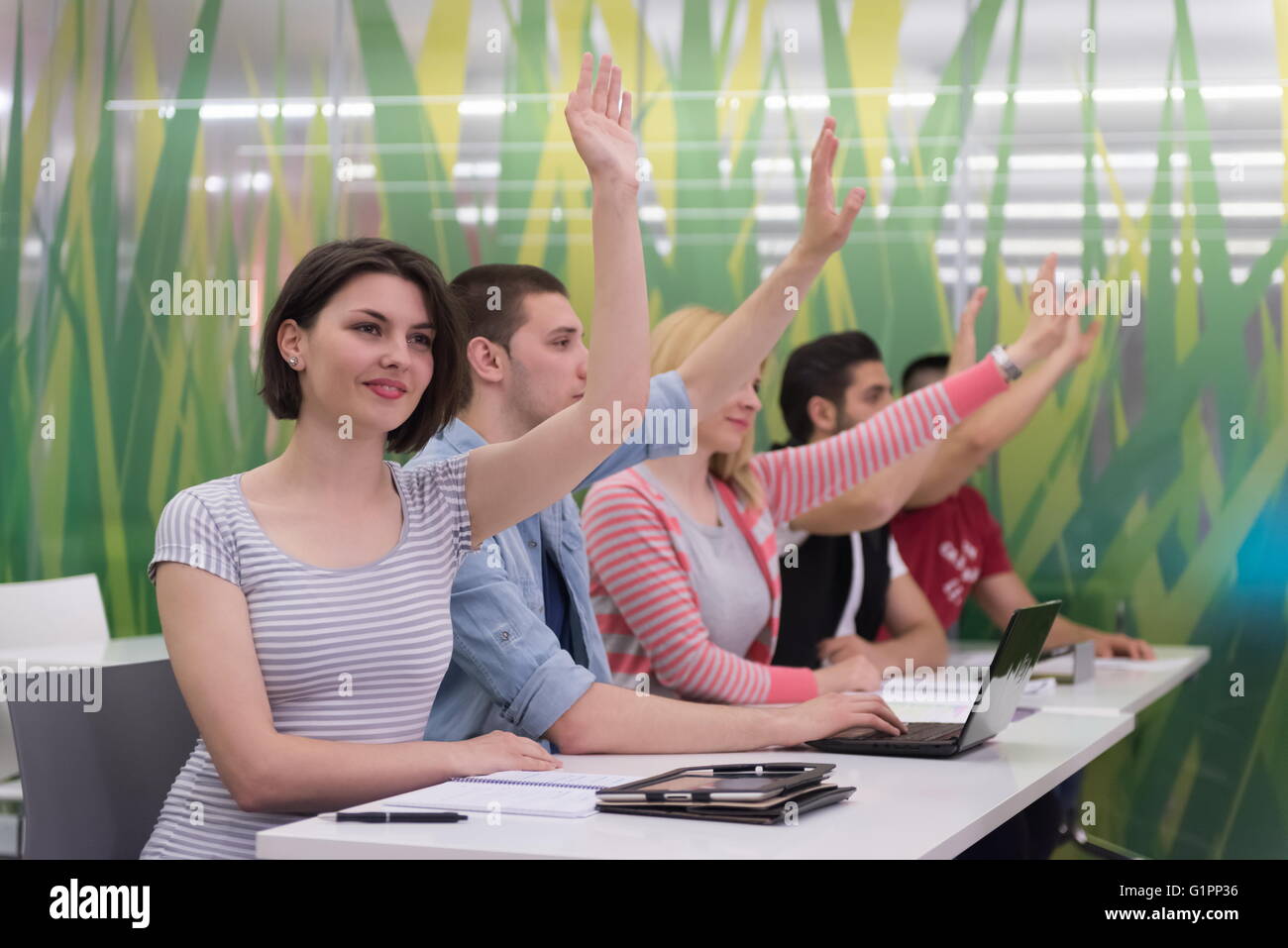 teacher teaching lessons, smart students group raise hands up in school ...