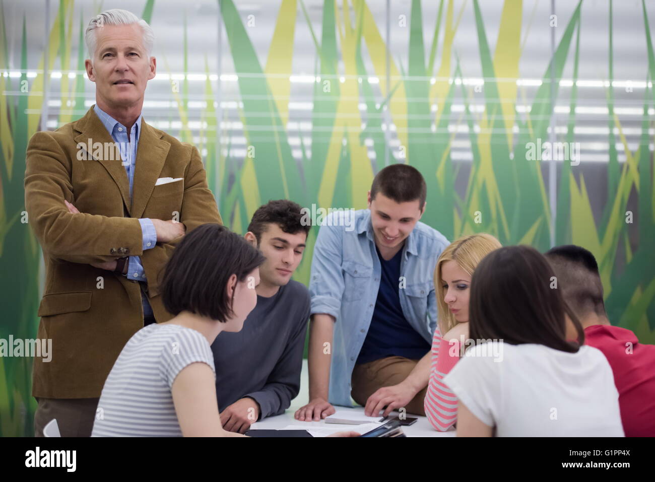 portrait of confident teacher, students group in background Stock Photo ...