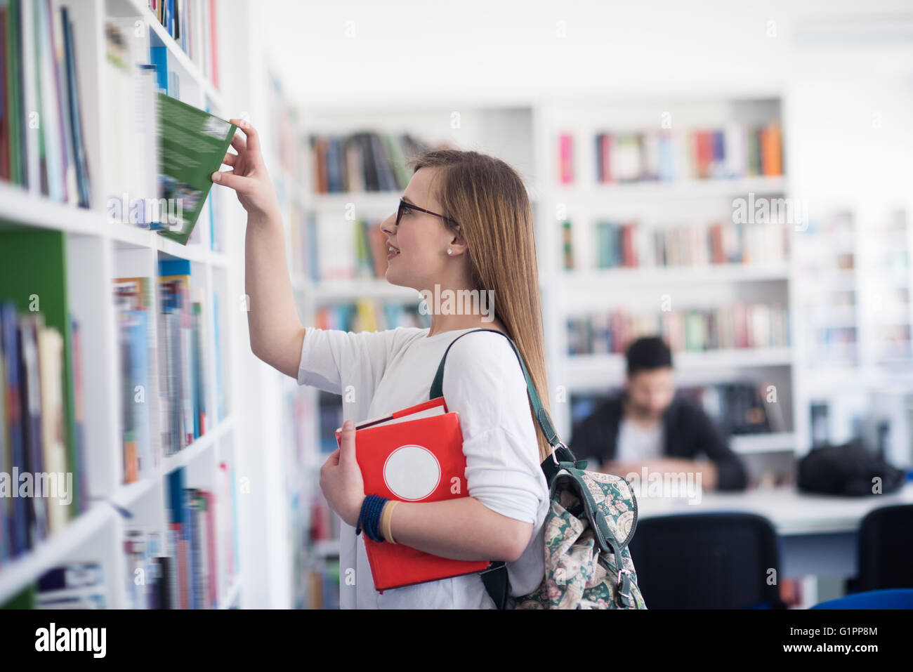 smart looking famale student girl in collage school library selecting ...