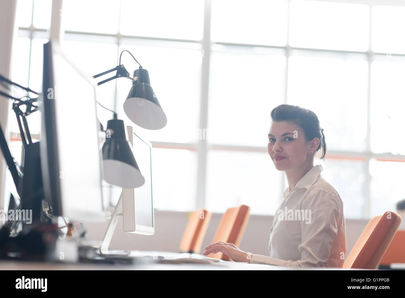 business woman working on desktop computer at modern startup office ...