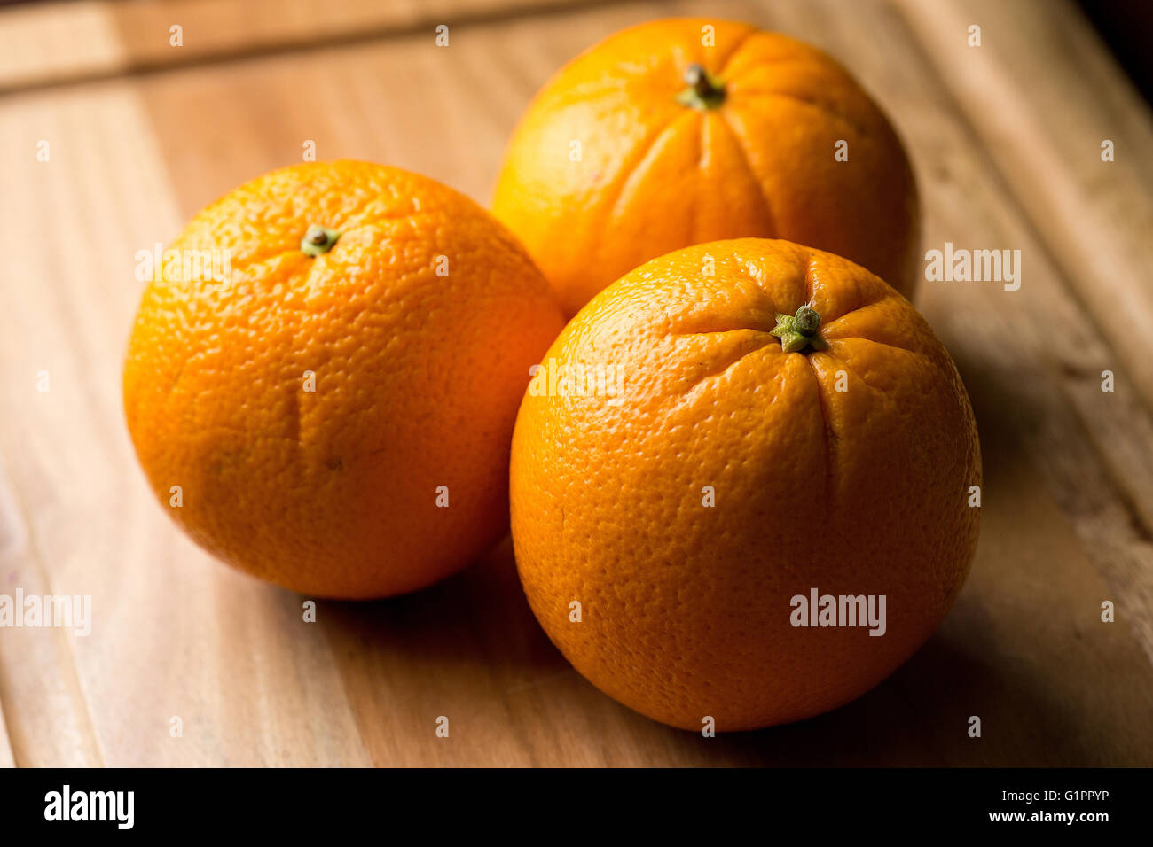 Three Oranges in the table Stock Photo - Alamy