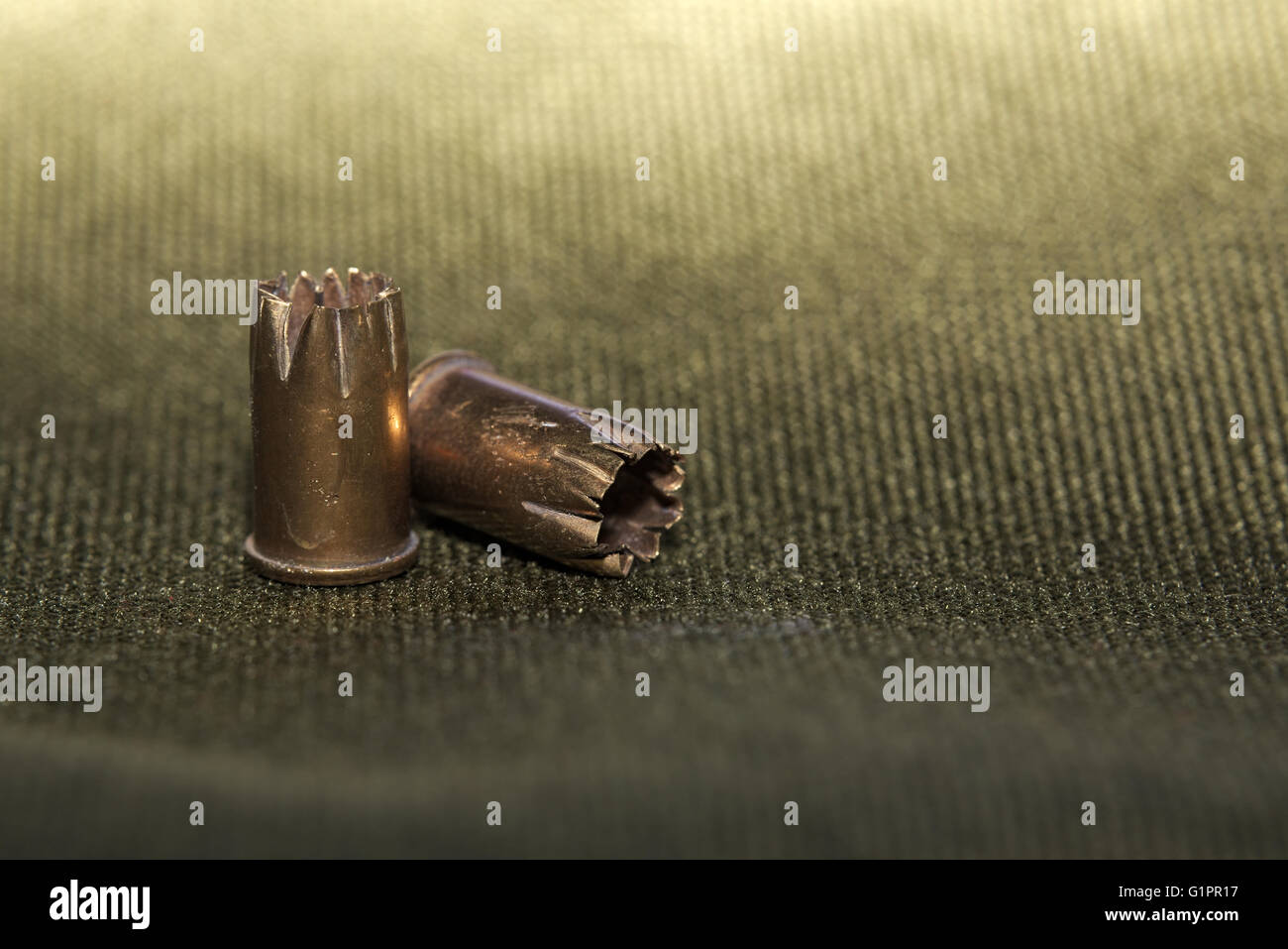 Bullet casings on green textile with selective focus and unusual ...
