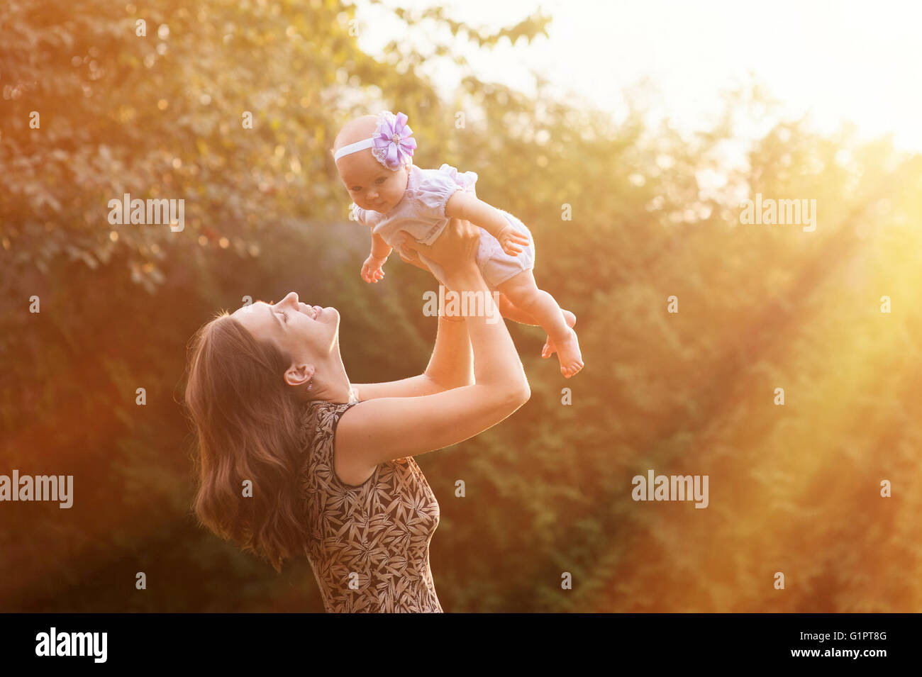 young mother holding daughter in her arms Stock Photo - Alamy