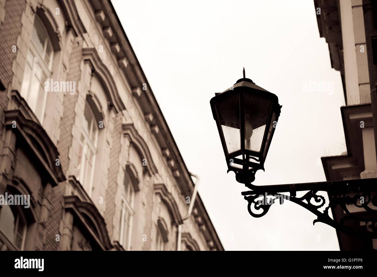 Vintage street lamp on wall of the building. Photo with sepia effect ...