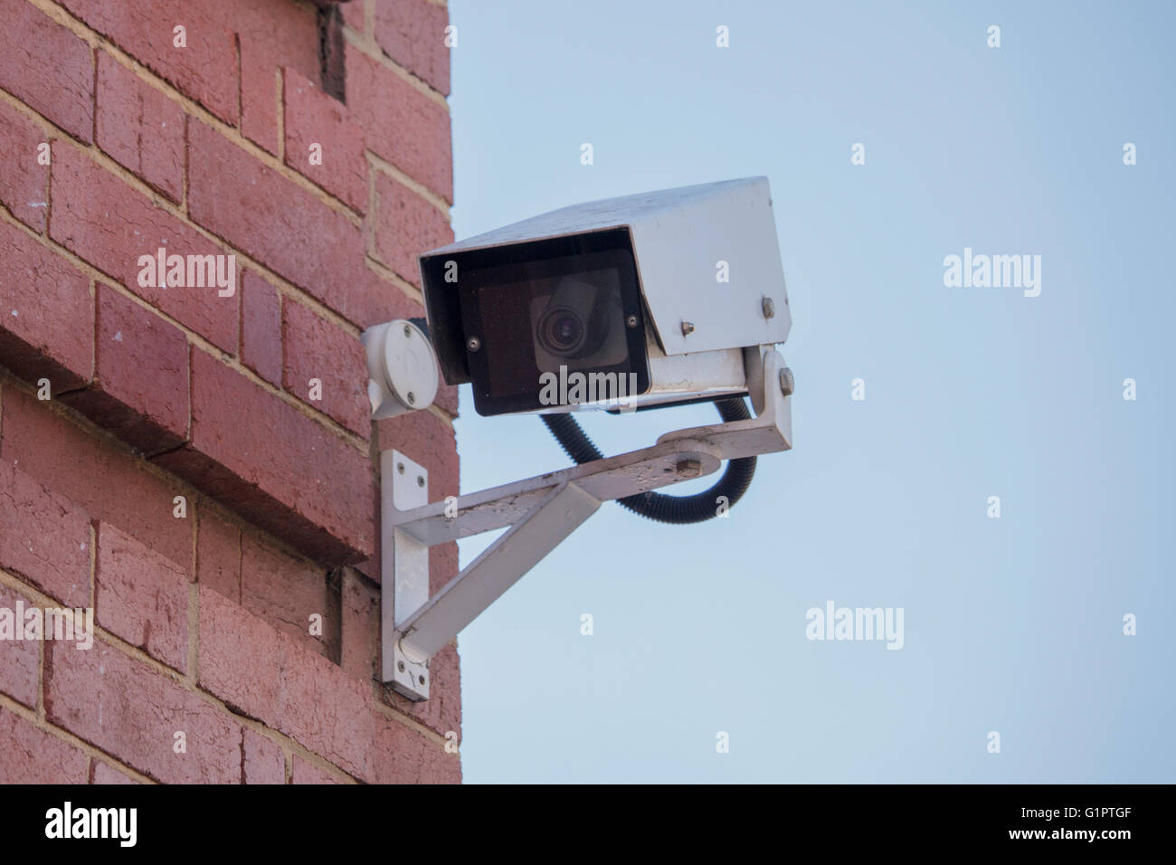 Surveillance/security camera mounted on wall Stock Photo - Alamy