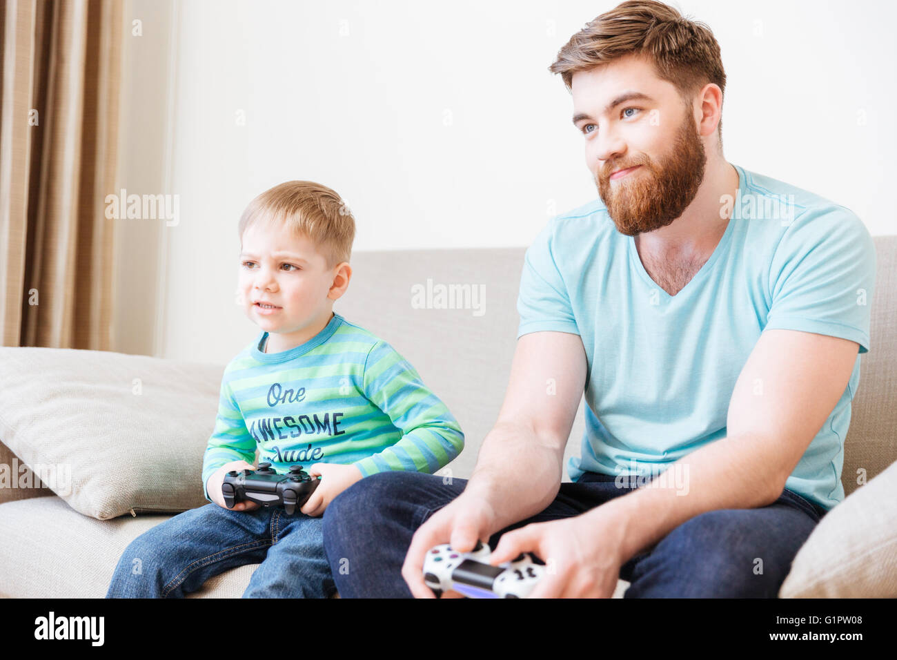 Sad unhappy dad and son playing computer games at home Stock Photo - Alamy
