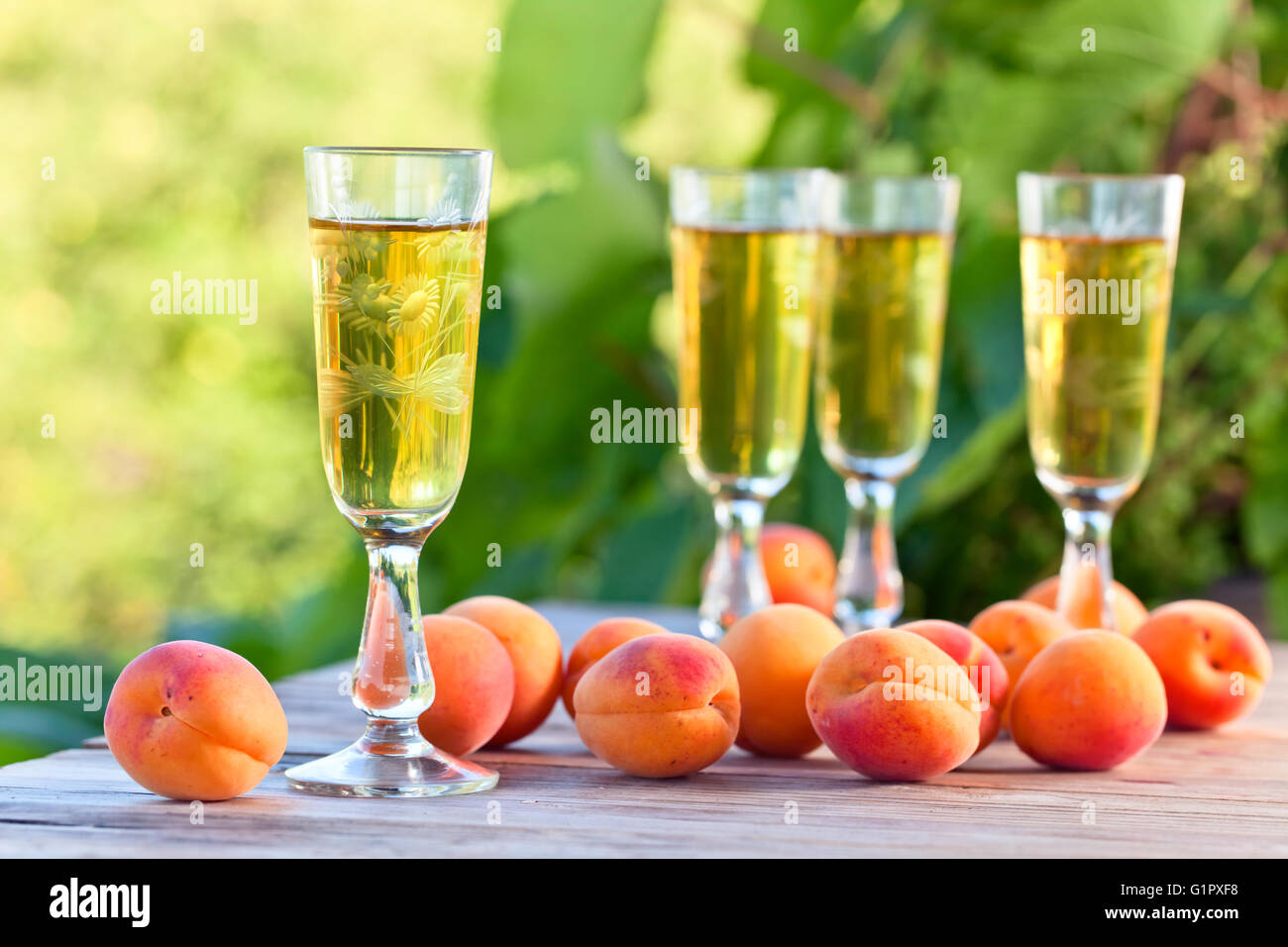 Apricot liquor and fruits on wooden table Stock Photo - Alamy