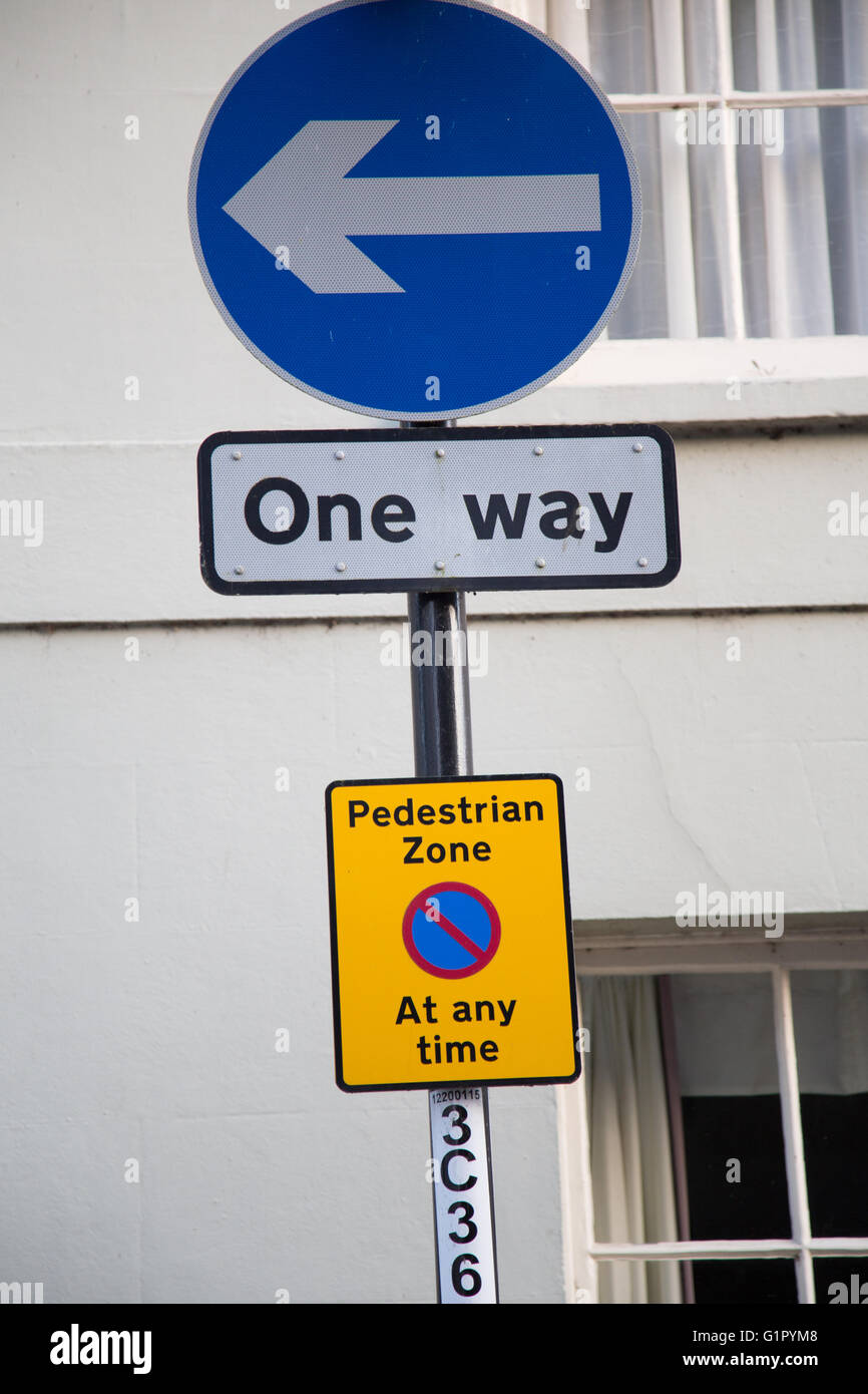 A one way sign with pedestrian zone and no parking restriction Stock ...