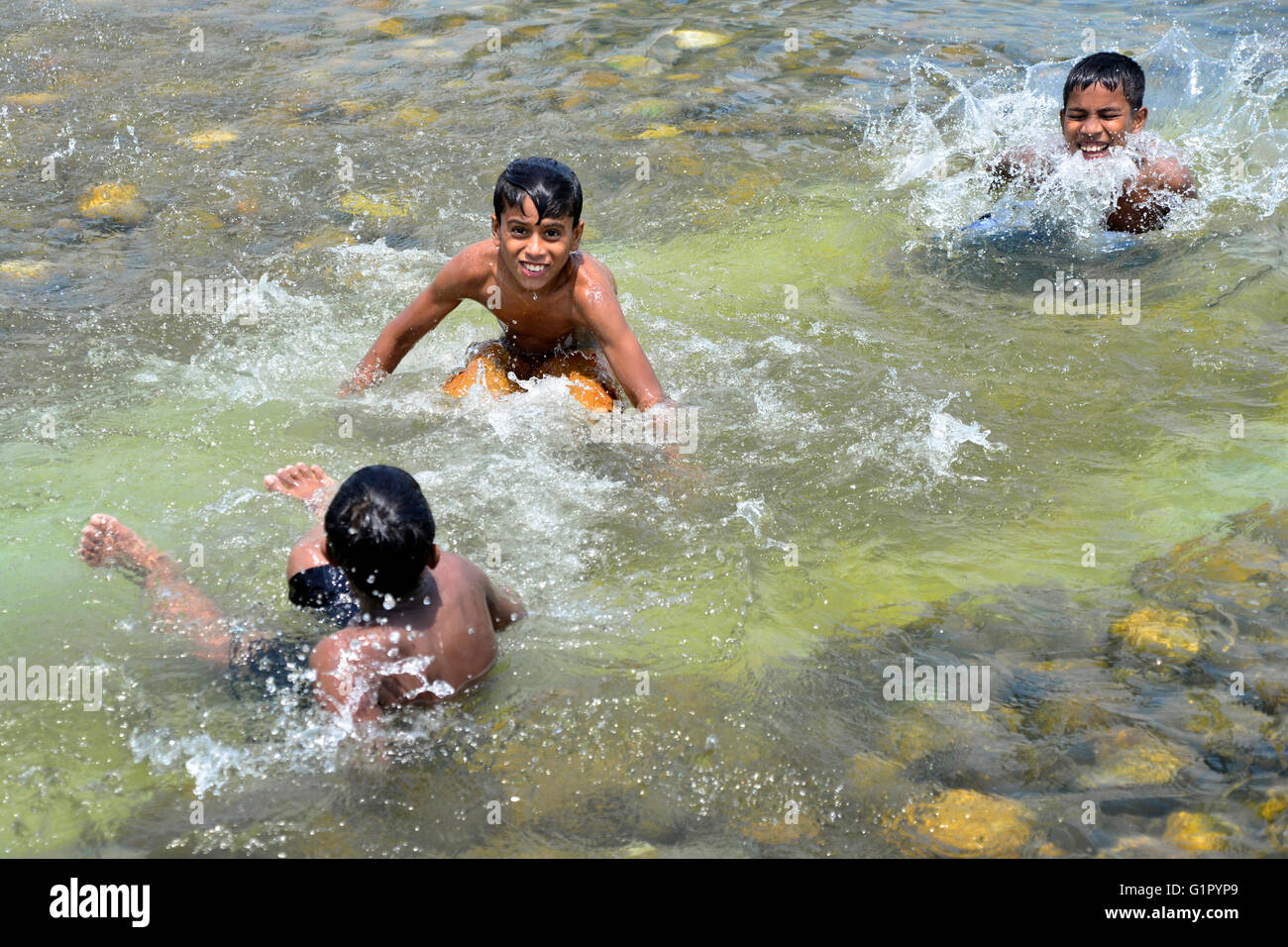 Indian kids bathing playing water hi-res stock photography and images ...