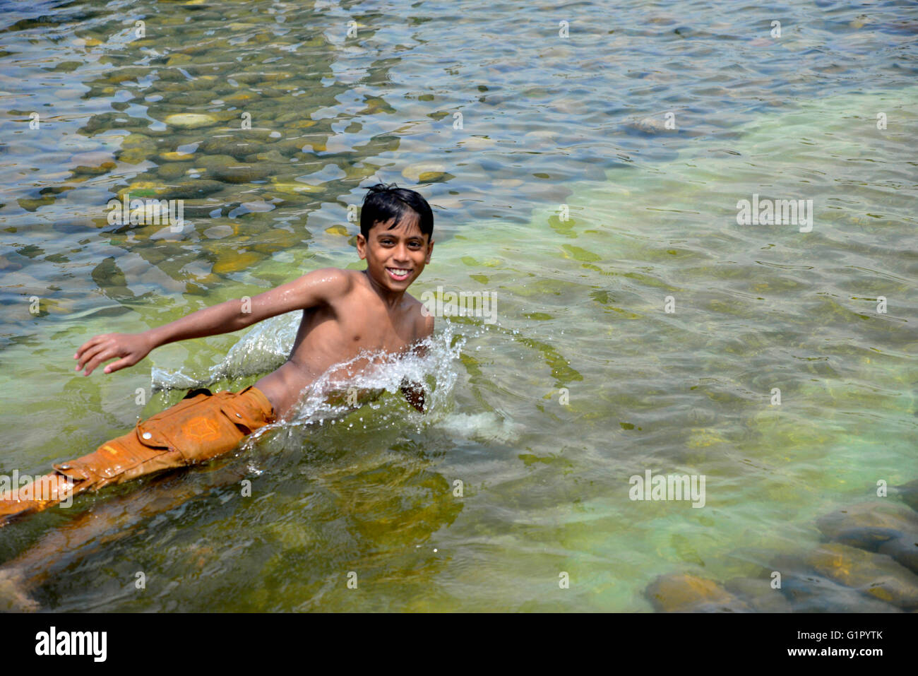 Indian kids bathing playing water hi-res stock photography and images ...