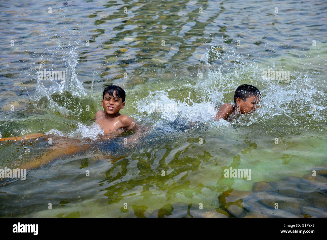 Indian kids bathing playing water hi-res stock photography and images ...