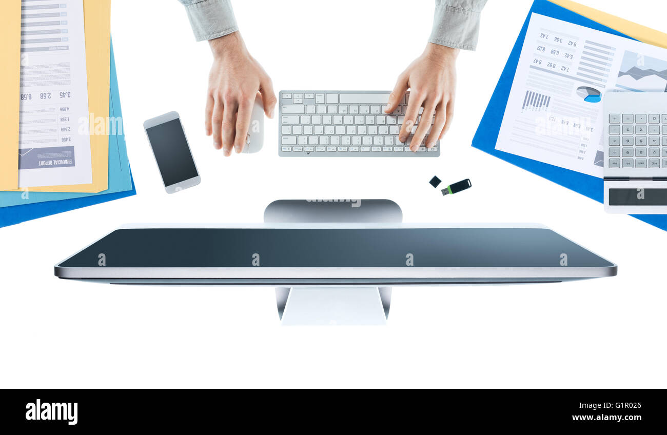 Businessman working at office desk and using a computer, hands top view ...