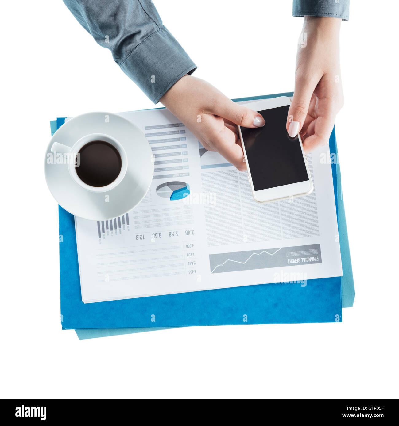 Business woman working at desk and using a touch screen smart phone ...