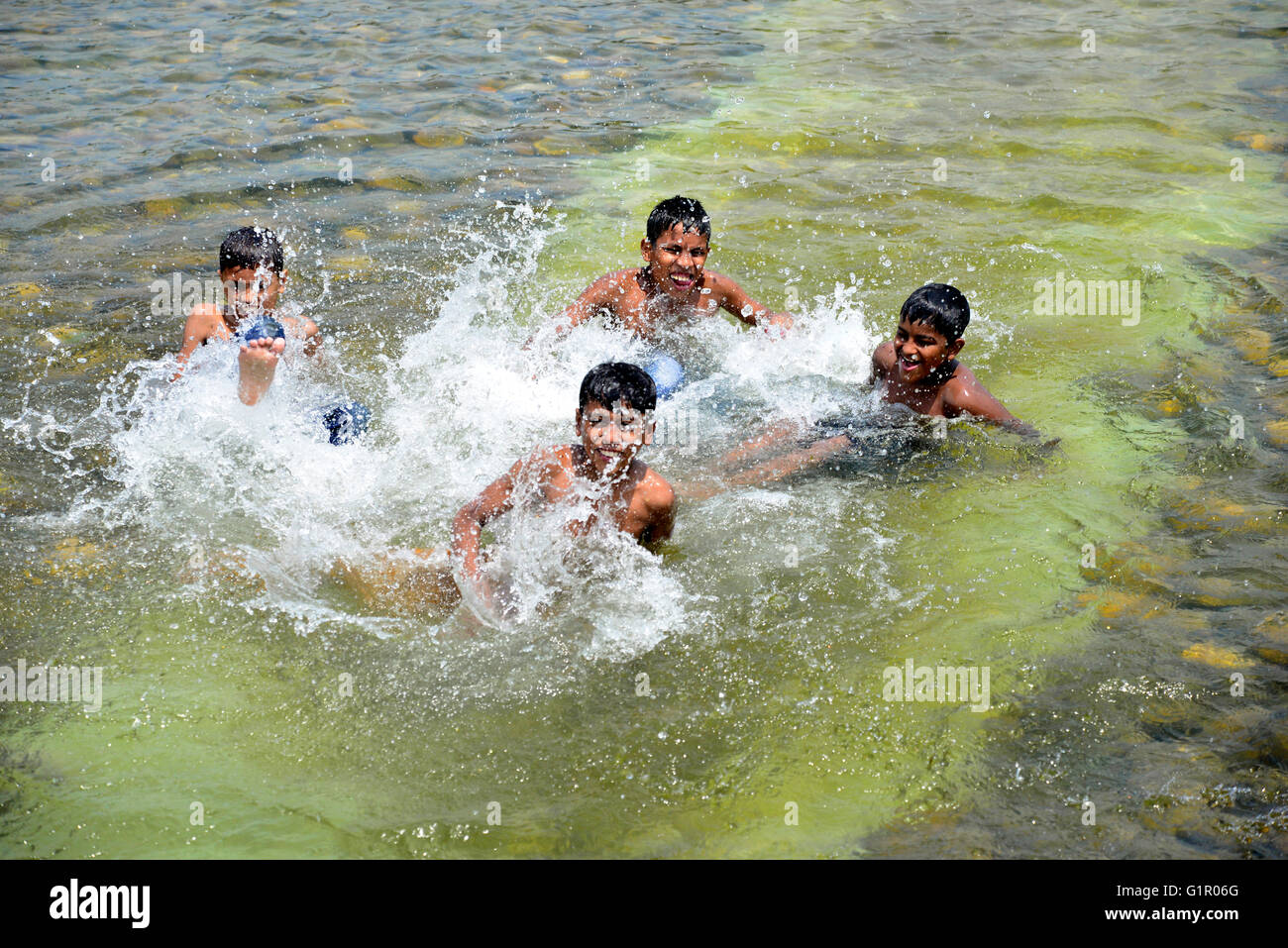 Indian kids bathing playing water hi-res stock photography and images ...