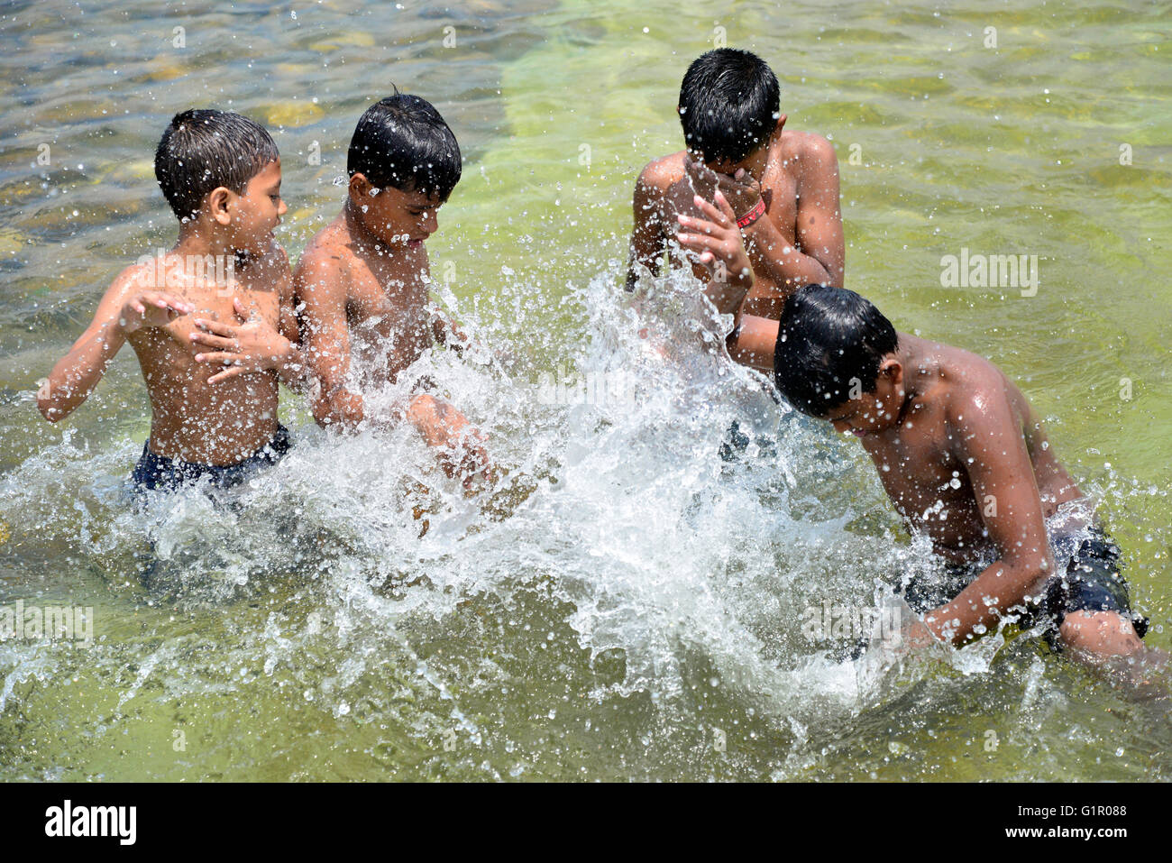 Indian kids bathing playing water hi-res stock photography and images ...