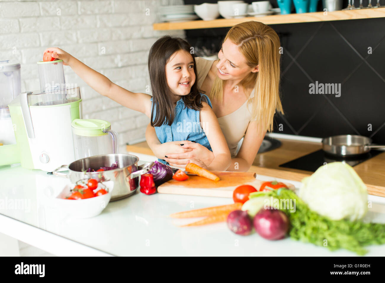 Mother and daughter preparing vegetables in the kitchen Stock Photo - Alamy