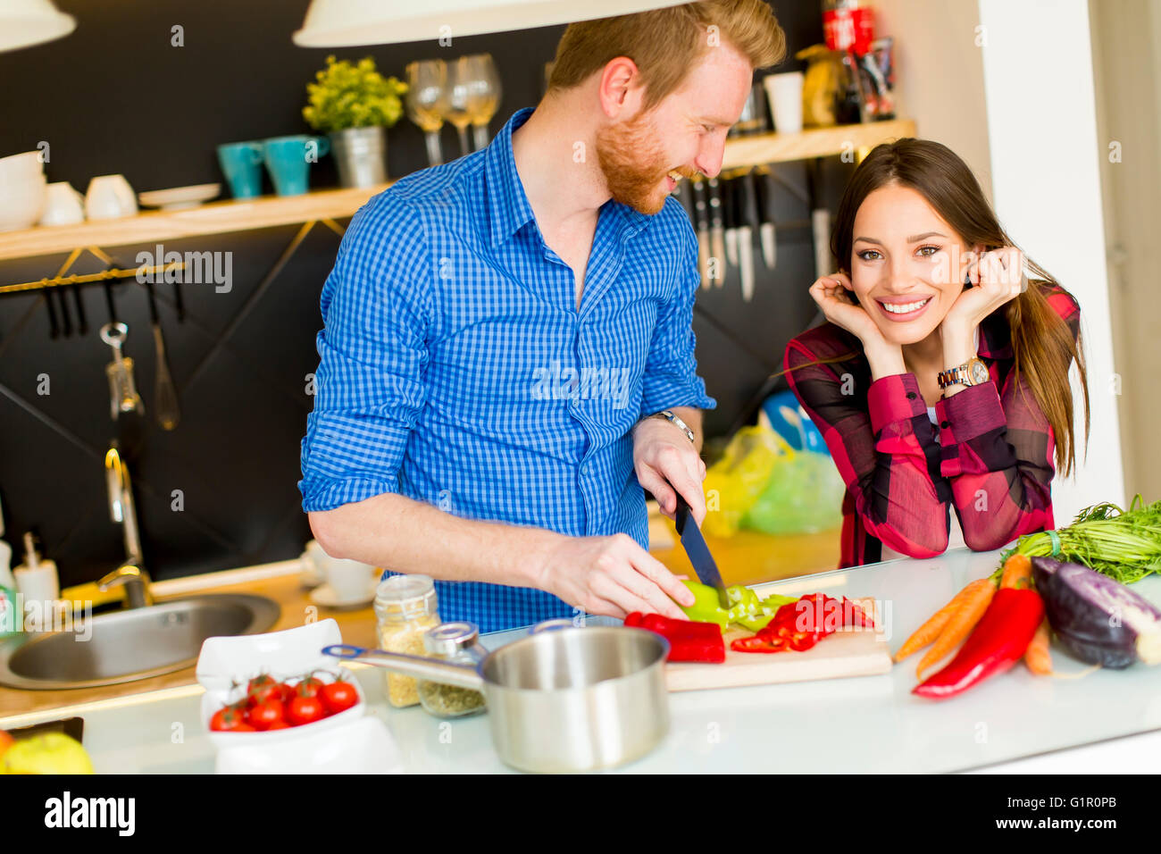 Couple cooking together in the kitchen at home Stock Photo - Alamy