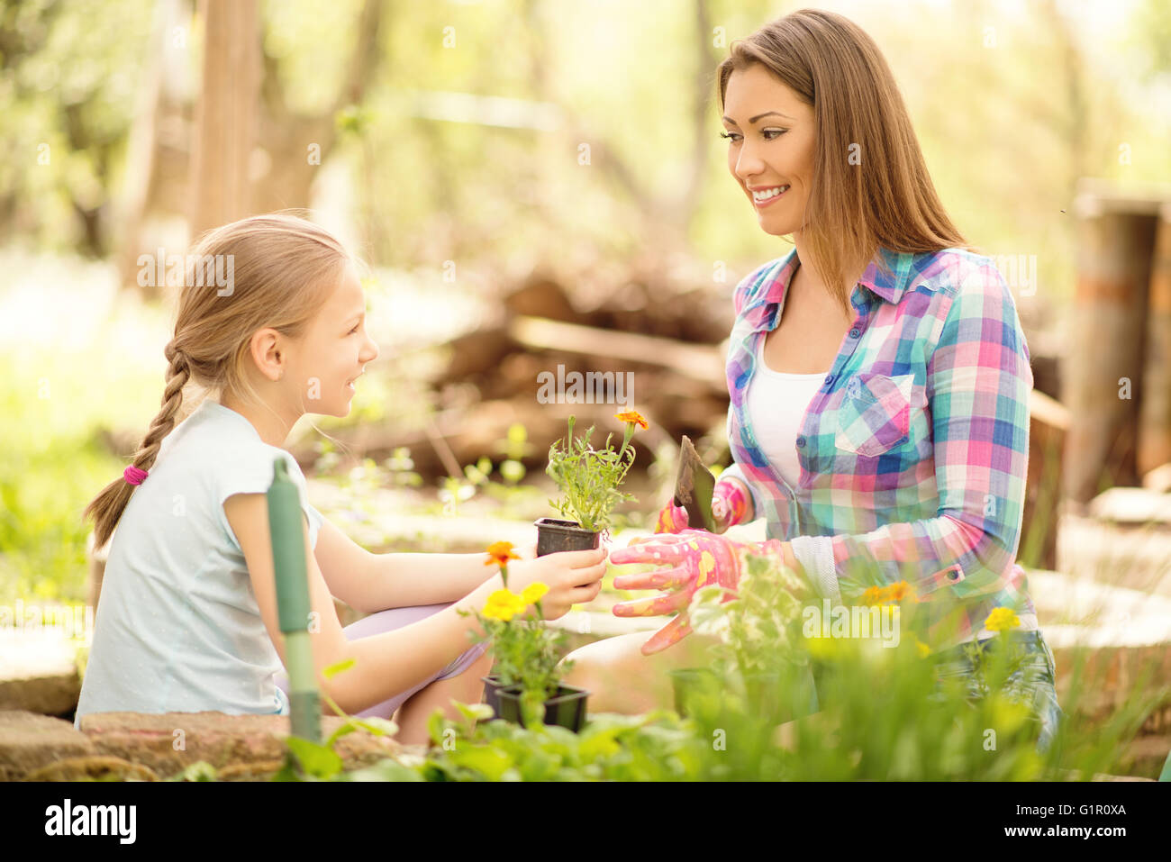 Mother And Daughter In Garden Stock Photo - Alamy