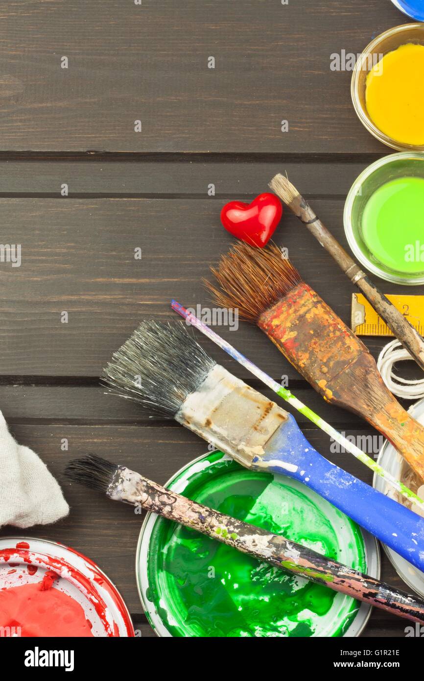 Brushes and paint on a wooden table. Painter tools. Workshop painter ...