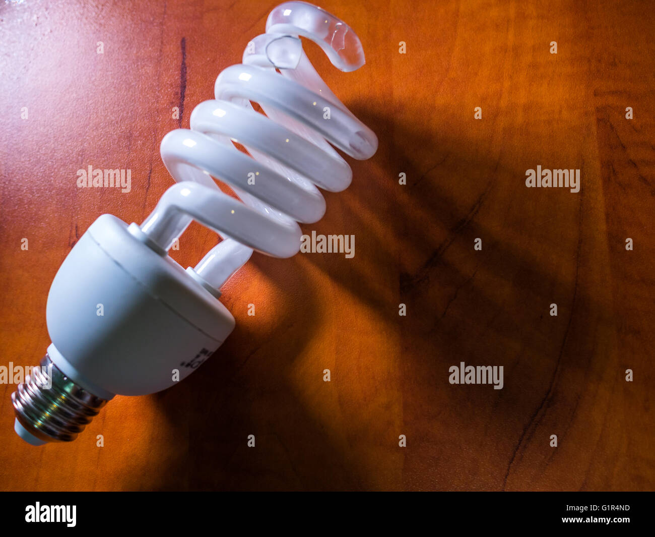 broken bulb light over brown background, shadow Stock Photo - Alamy