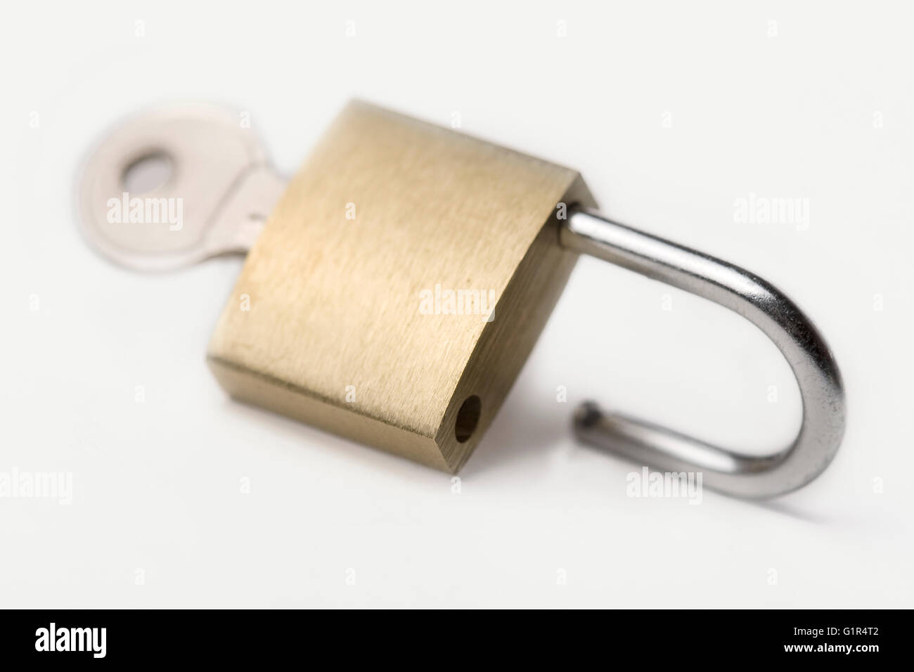 Horizontal side view of an open lock with key isolated on white ...