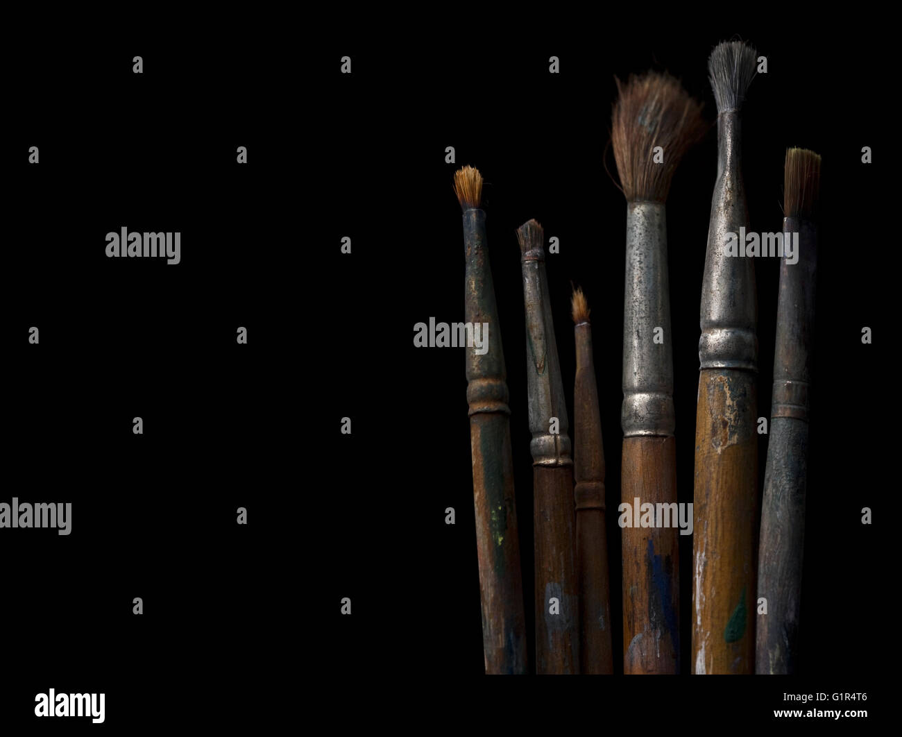 Horizontal front view of a set of heavily used painting brushes on ...