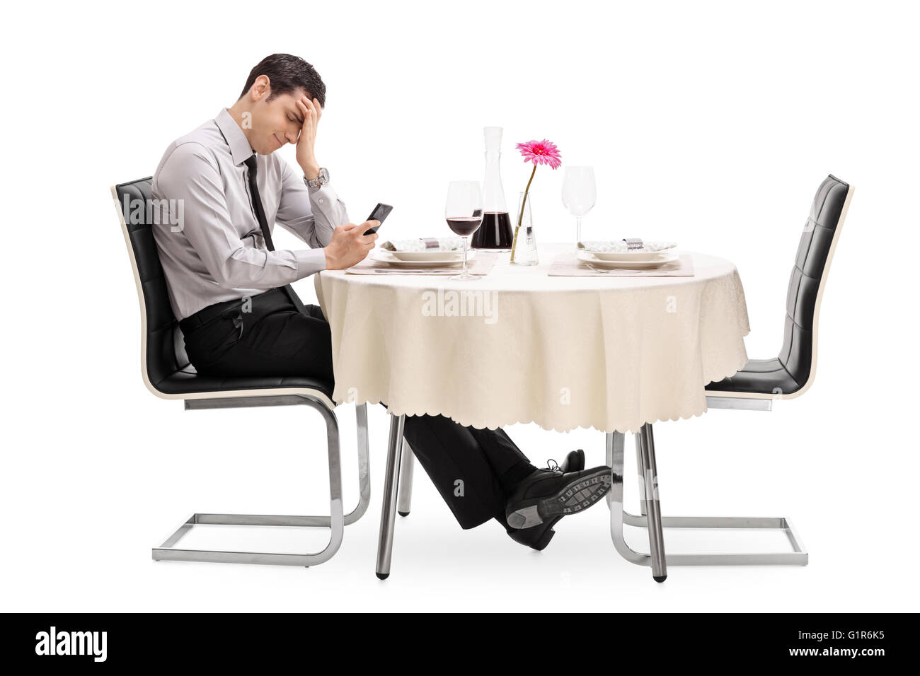 Disappointed young man reading a cancellation text message from his ...