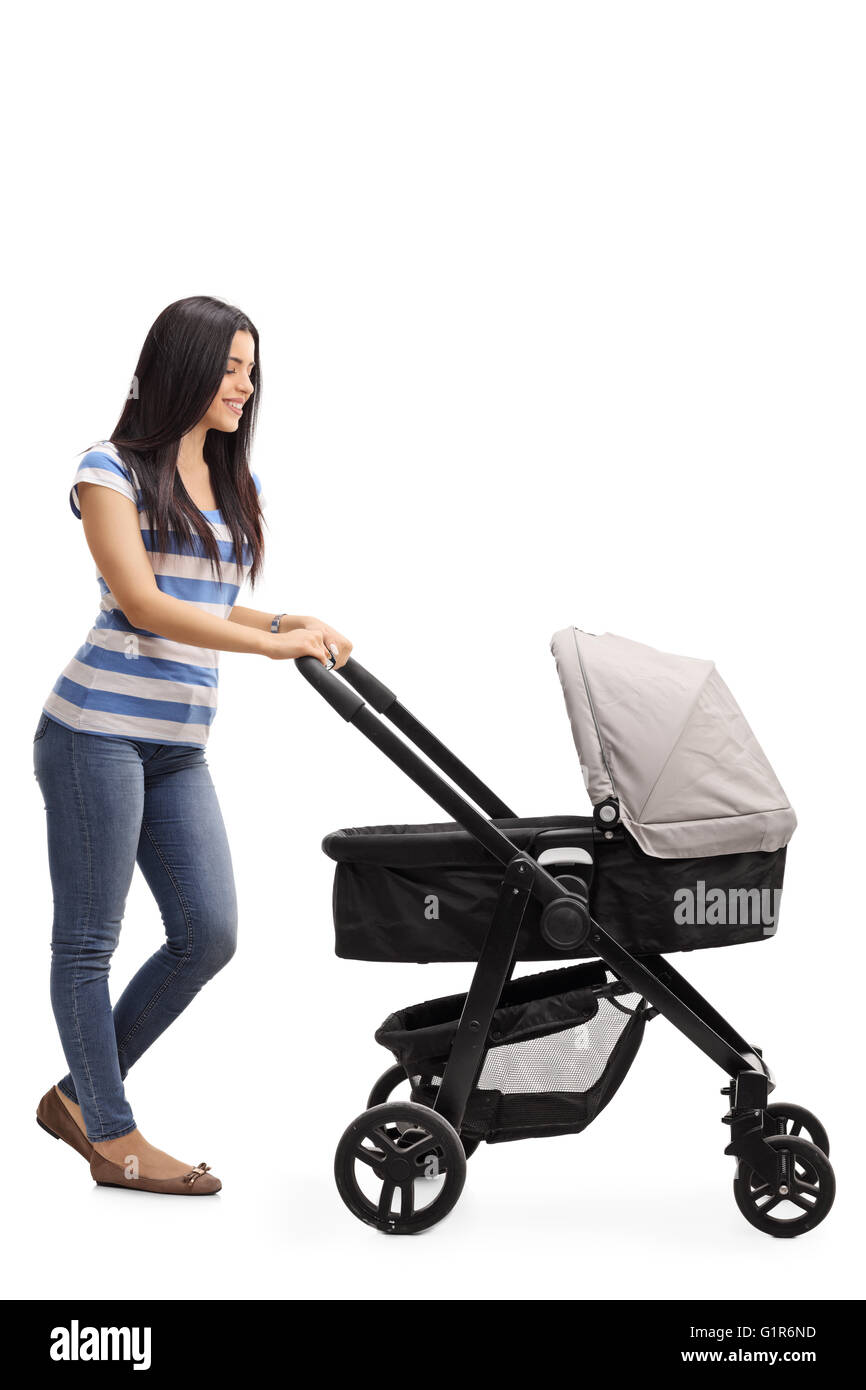 Full length portrait of a young mother pushing a baby stroller isolated ...