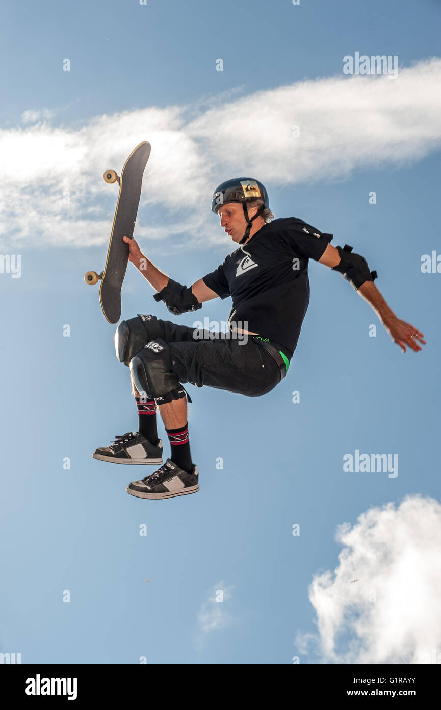 Professional skateboarder Tony Hawk demonstrating moves on the seafront ...