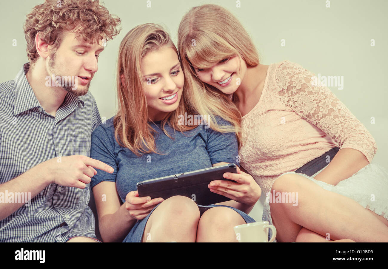 Friends browsing surfing internet on tablet. Young people man guy and ...