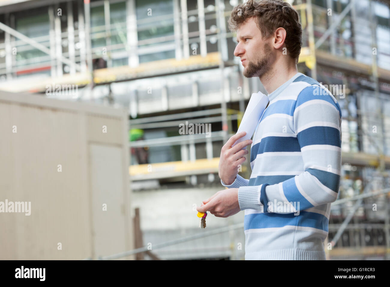 Real estate concept - young man on front of new big modern house ...