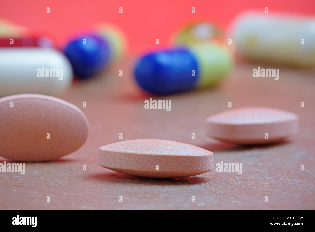 Close up of statin tablet or generic pill with out of focus tablets in ...