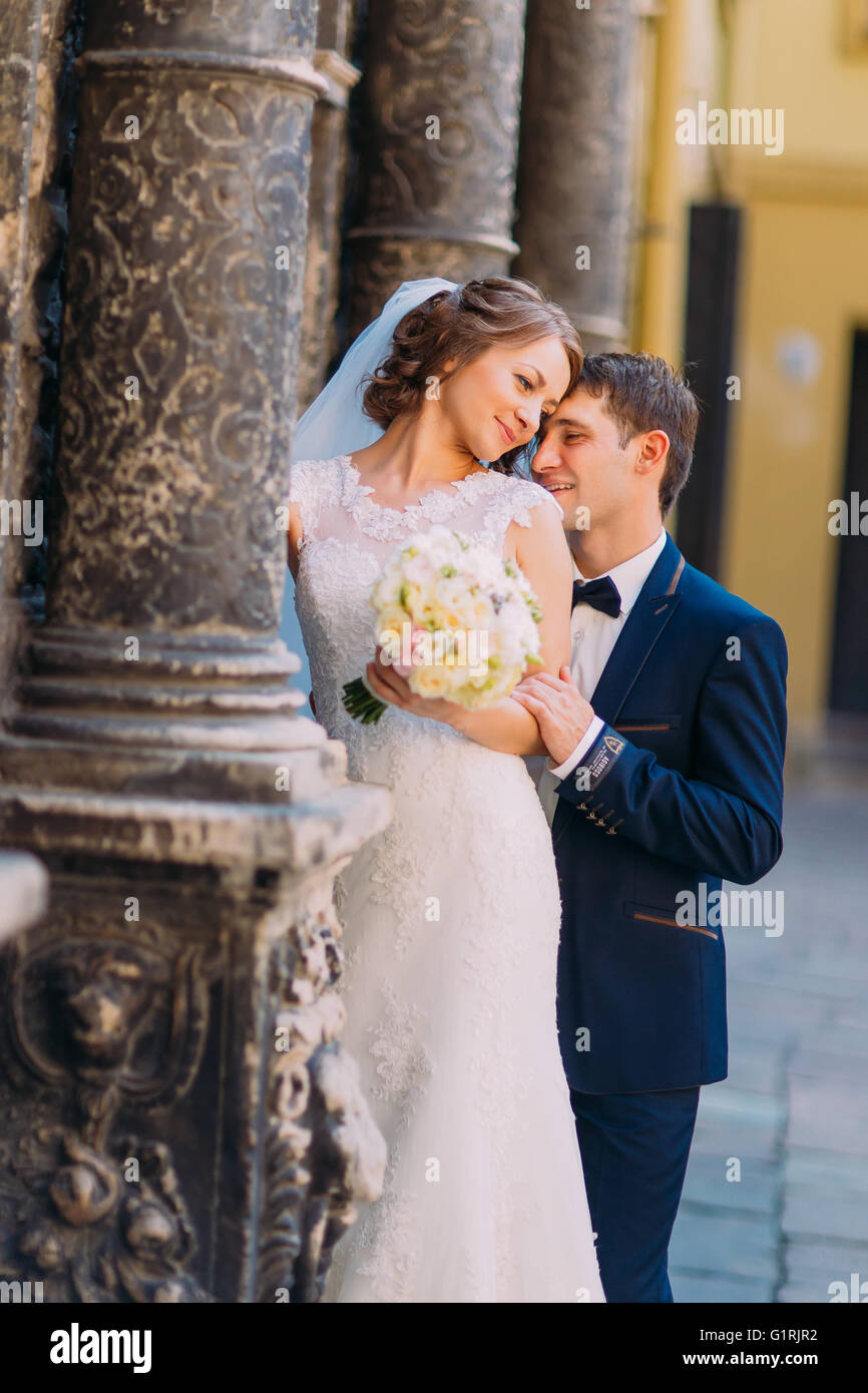 Sensual romantic groom hugging beautiful bride from behind, touching ...