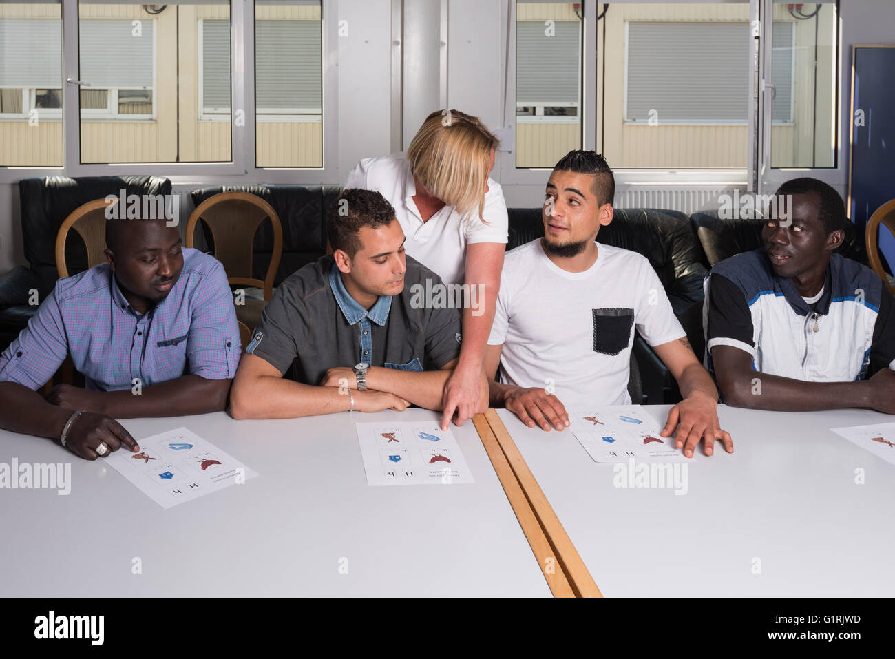 Language training for refugees in a German camp Stock Photo - Alamy