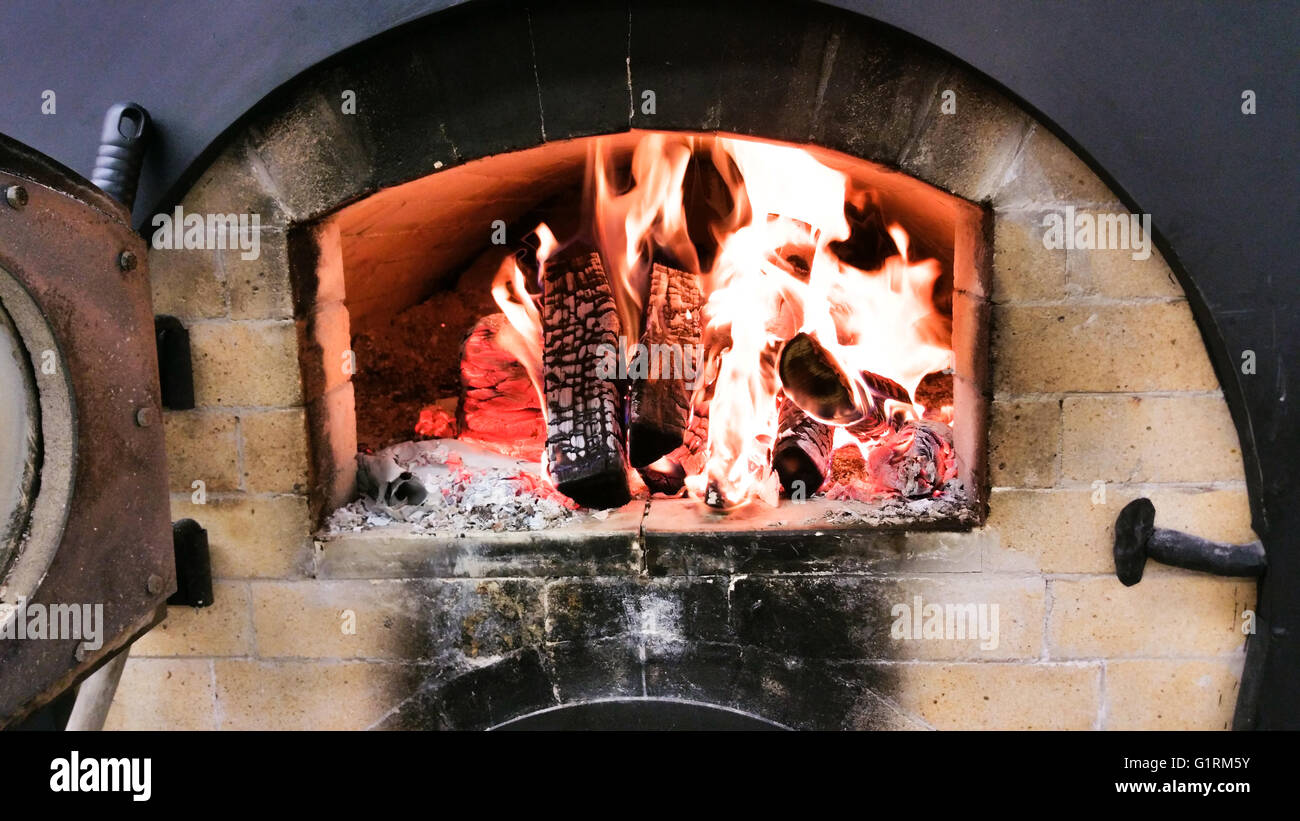 Fire burning inside a wooden warmed stone oven Stock Photo - Alamy