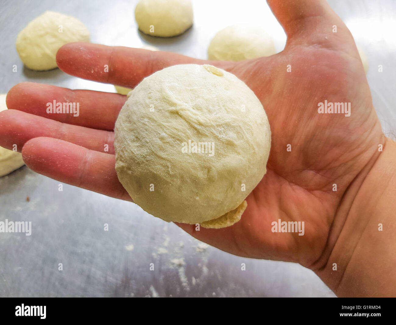 Baker making round bread rolls, at a bakery Stock Photo - Alamy