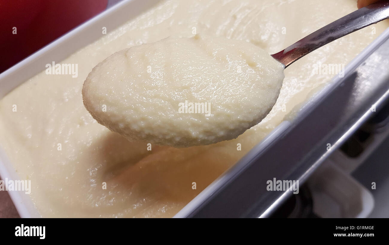 Garlic paste on a spoon, infront of more puree Stock Photo - Alamy