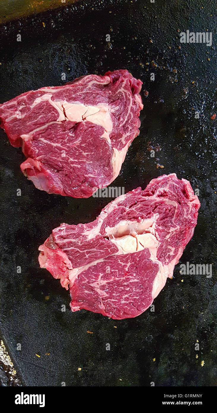 Raw entrecote, of black angus cow meat, on a frying pan Stock Photo - Alamy