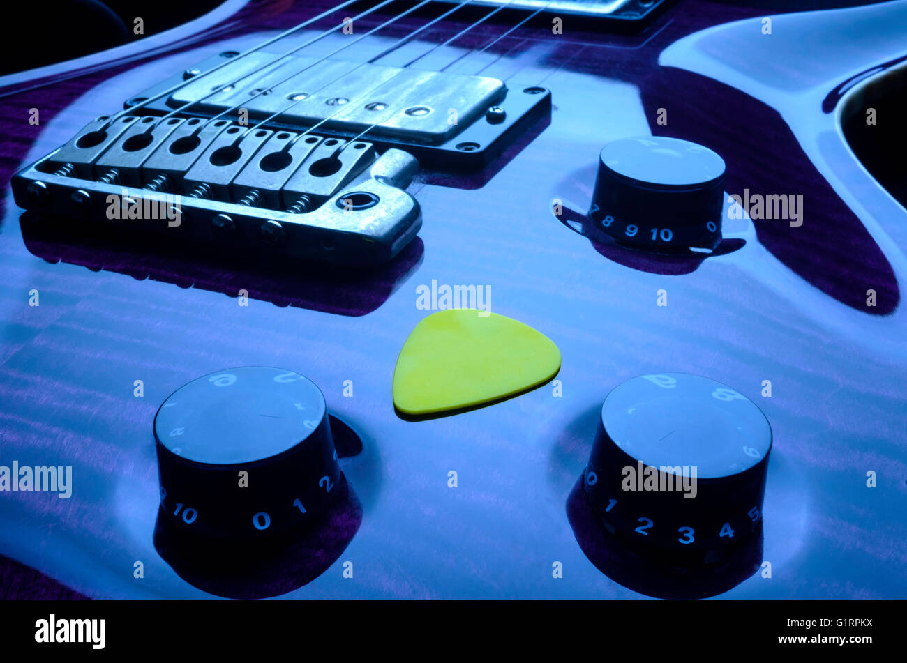 Purple guitar with yellow pick Stock Photo - Alamy