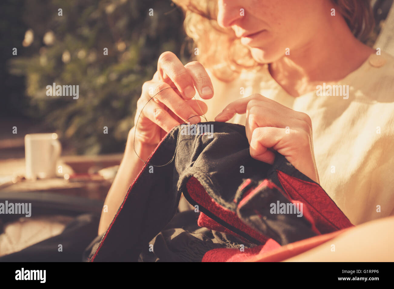 Woman sewing needle hi-res stock photography and images - Alamy